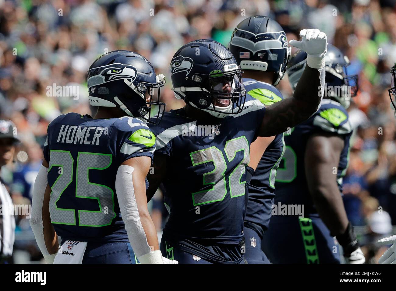 Seattle Seahawks running back Chris Carson (32) celebrates with running ...