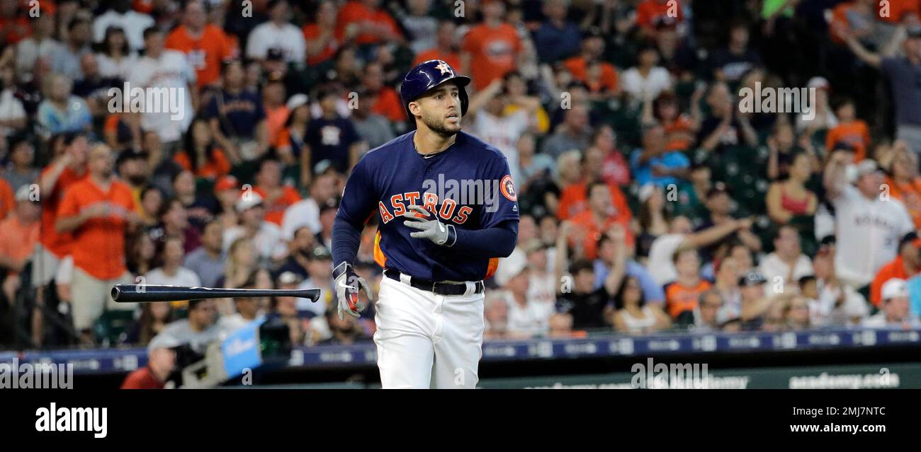 Houston Astros' George Springer tosses his bat after hitting a three ...
