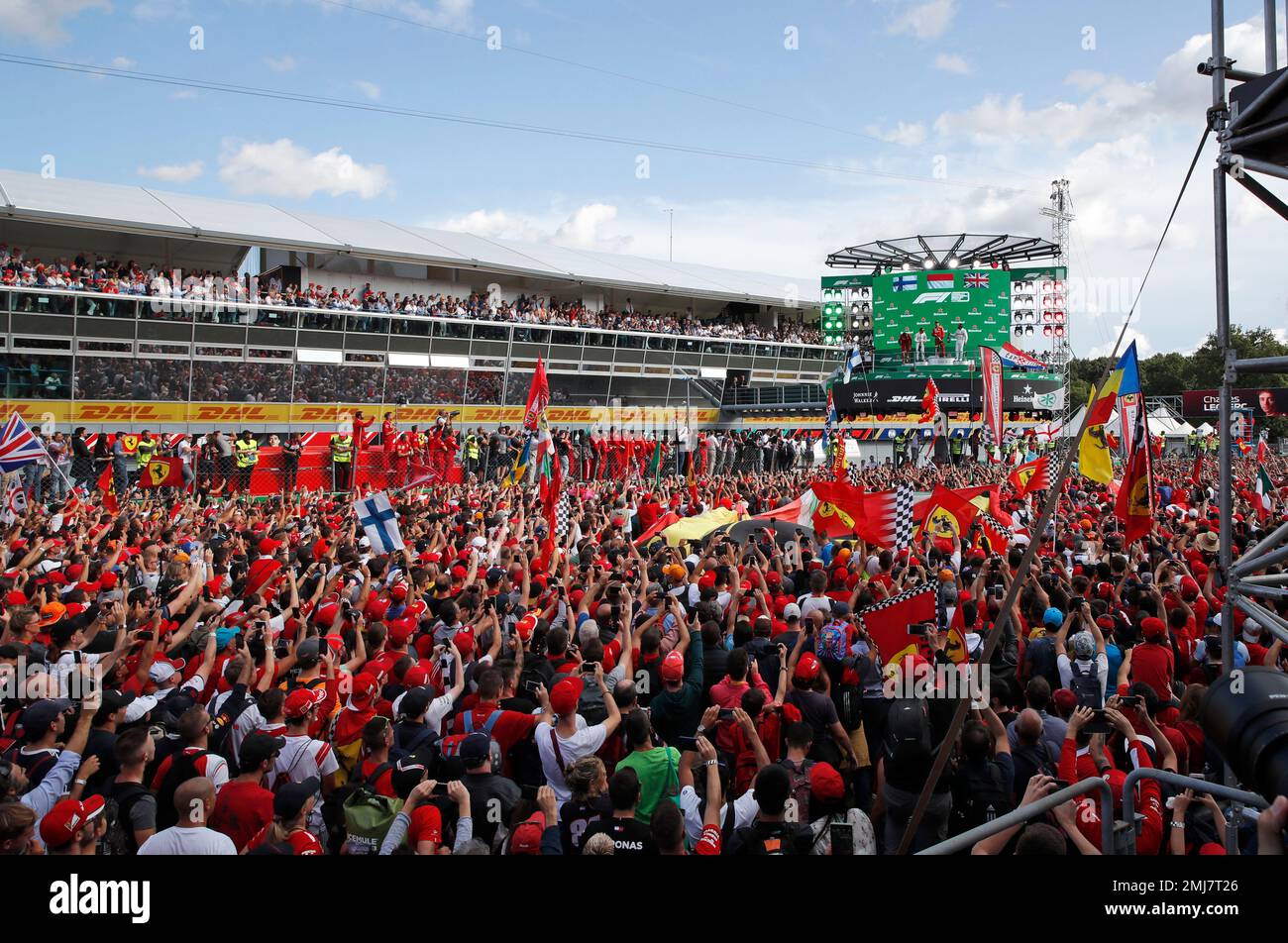 Ferrari fans celebrate under the podium after Ferrari driver Charles ...