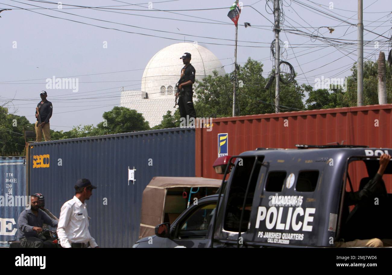 Pakistani police officer take position on shipping containers to ensure ...
