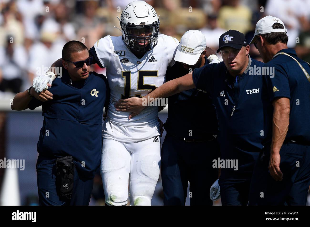 Georgia Tech head coach Geoff Collins checks on injured linebacker ...