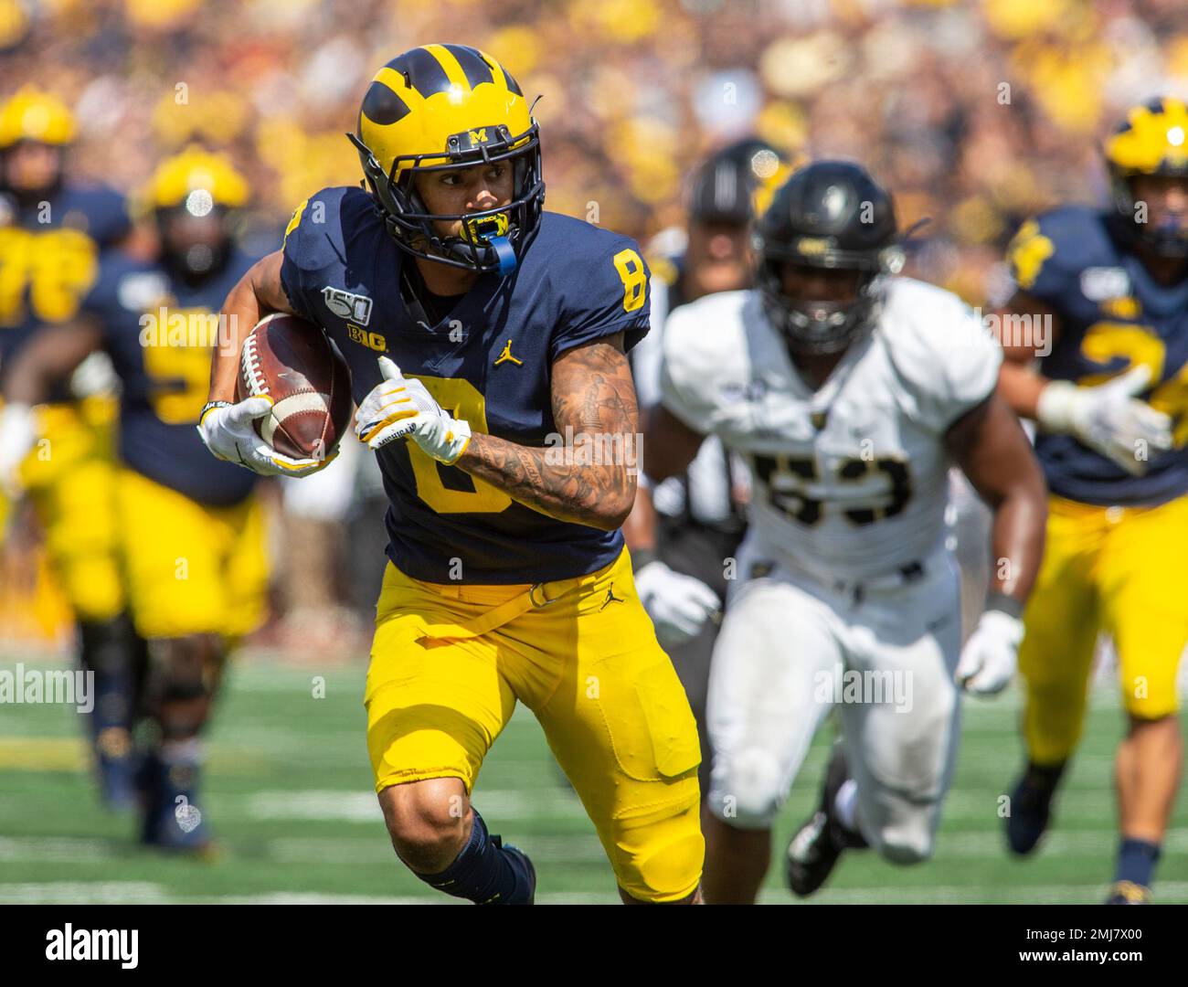Michigan wide receiver Ronnie Bell (8) rushes after reception in the ...