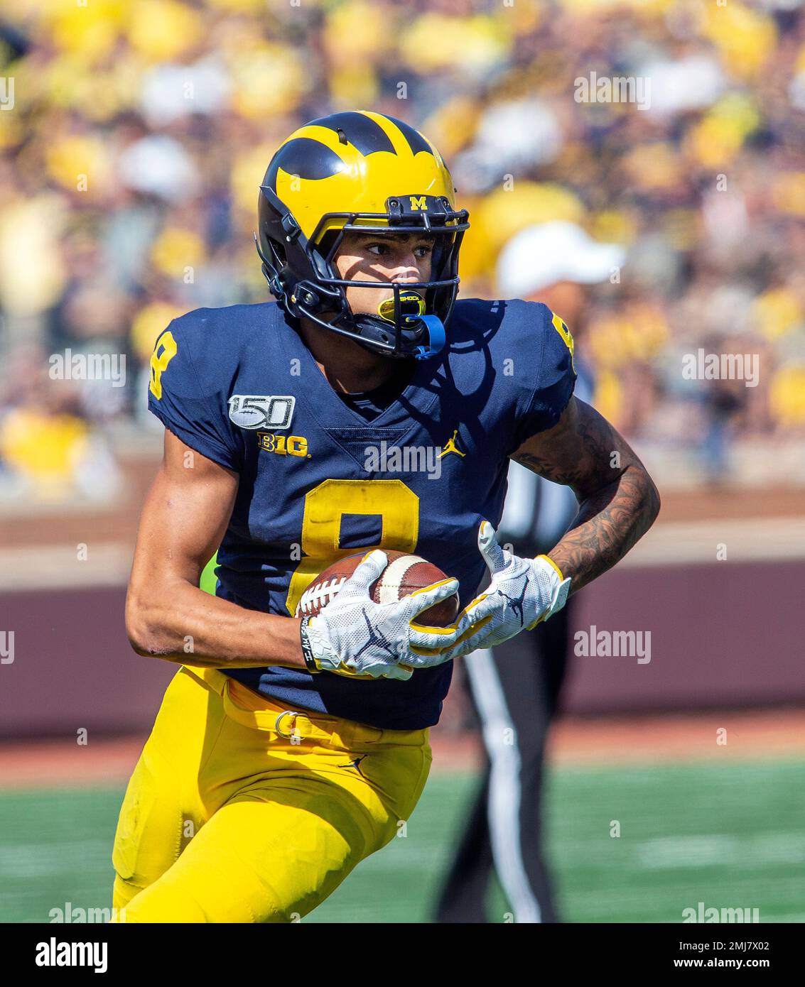Michigan wide receiver Ronnie Bell rushes after a reception in the ...