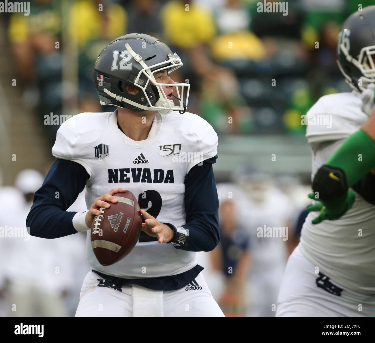 Nevada quarterback Carson Strong looks downfield under pressure from ...