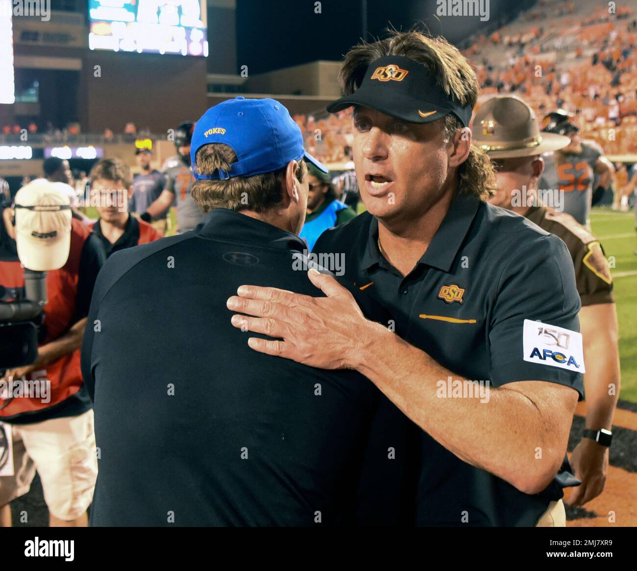 Oklahoma State head coach Mike Gundy, right, shakes hands with McNeese ...