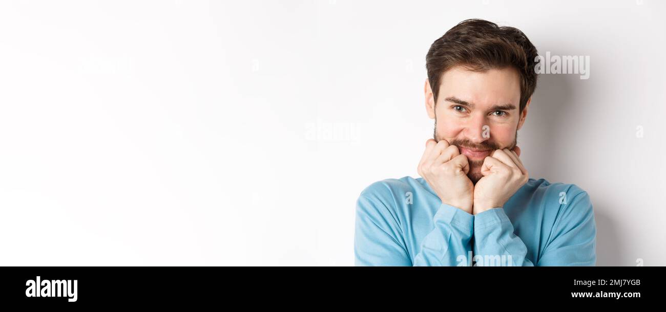 Cute caucasian man looking at something with admiration and desire ...