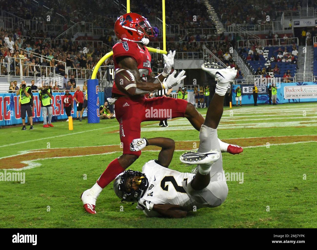 Florida Atlantic safety Zyon Gilbert, top, defends against UCF running ...