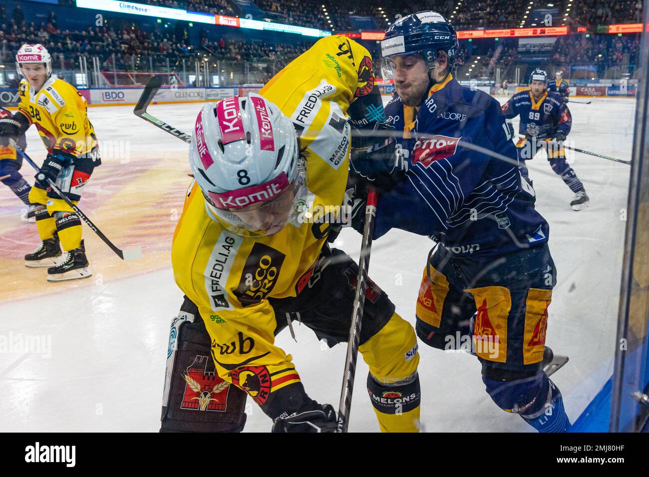 Sven Leuenberger #61 (EV Zug) against Joshua Fahrni #8 (SC Bern) during ...