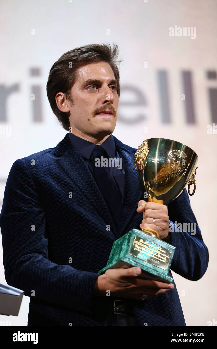 Actor Luca Marinelli holds the Coppa Volpi for Best Actor for his role ...