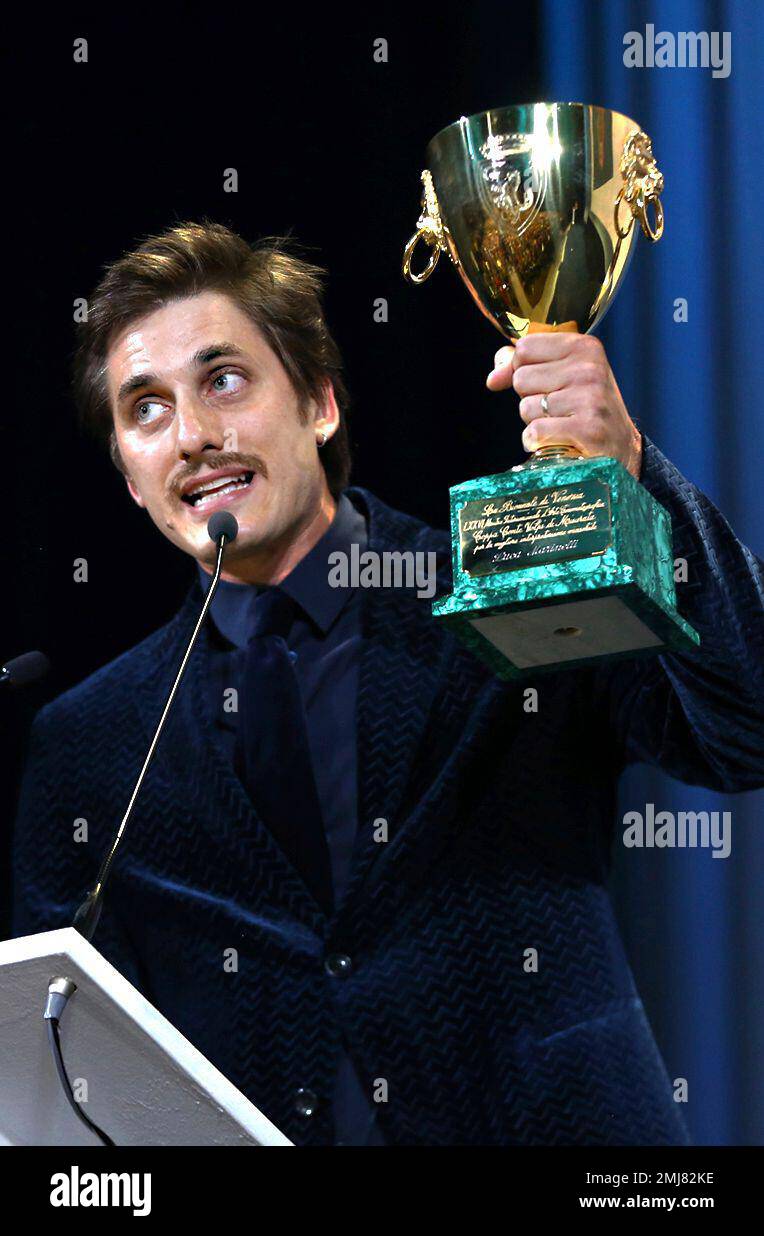 Actor Luca Marinelli holds the Coppa Volpi for Best Actor for his role ...