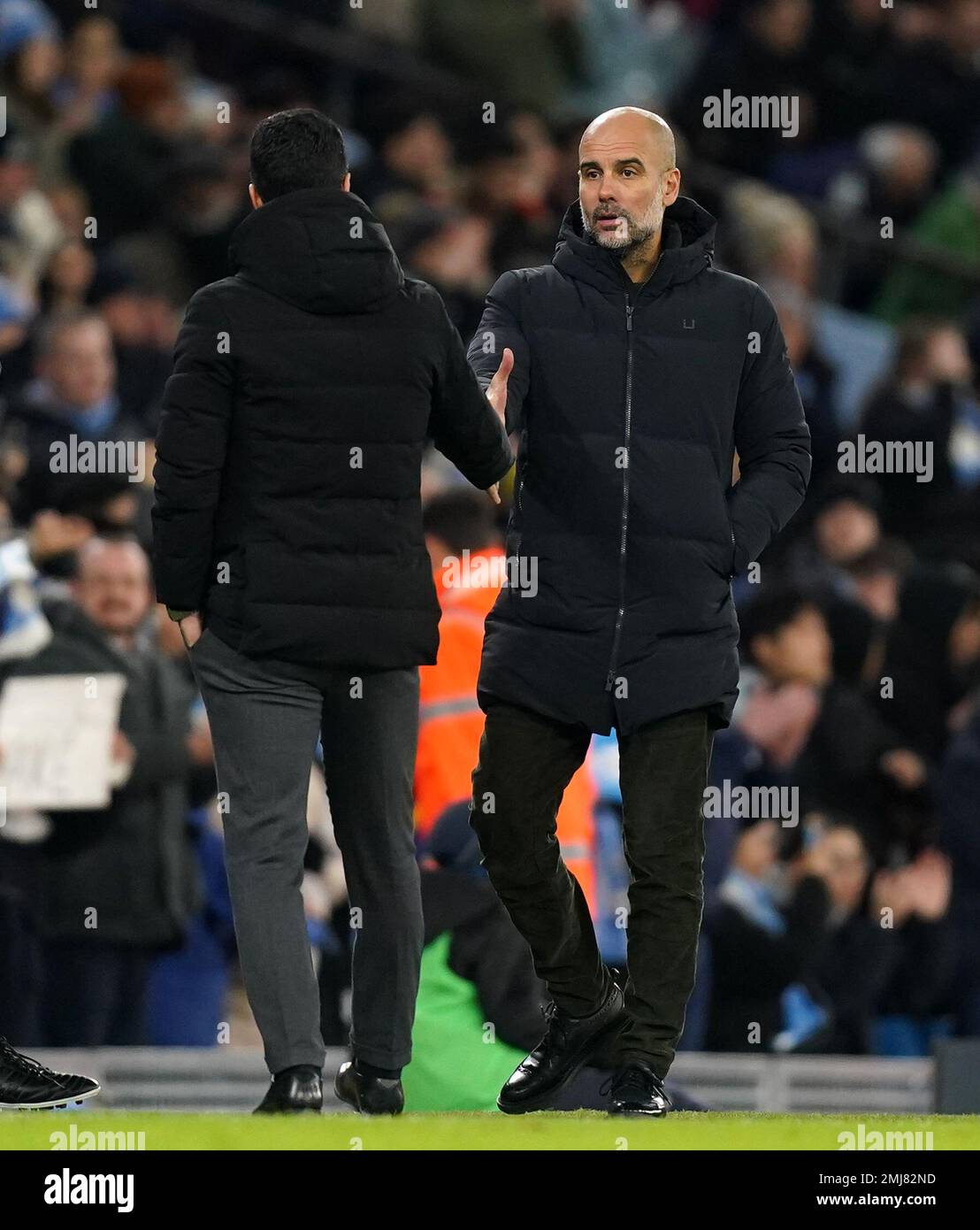 Arsenal manager Mikel Arteta (left) and Manchester City manager Pep ...