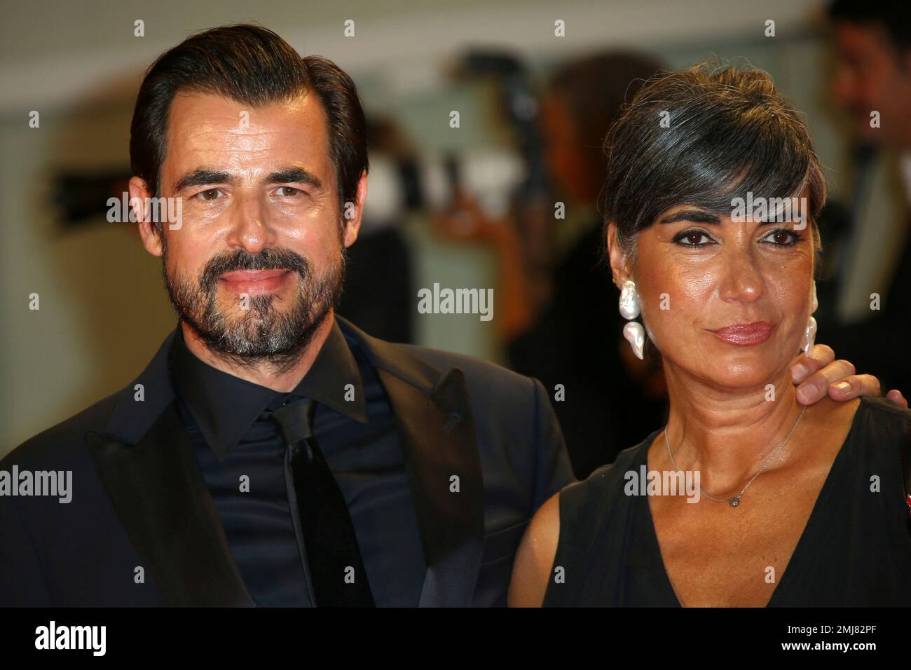 Actor Claes Bang, left, and Liz Louis-Jensen pose for photographers ...