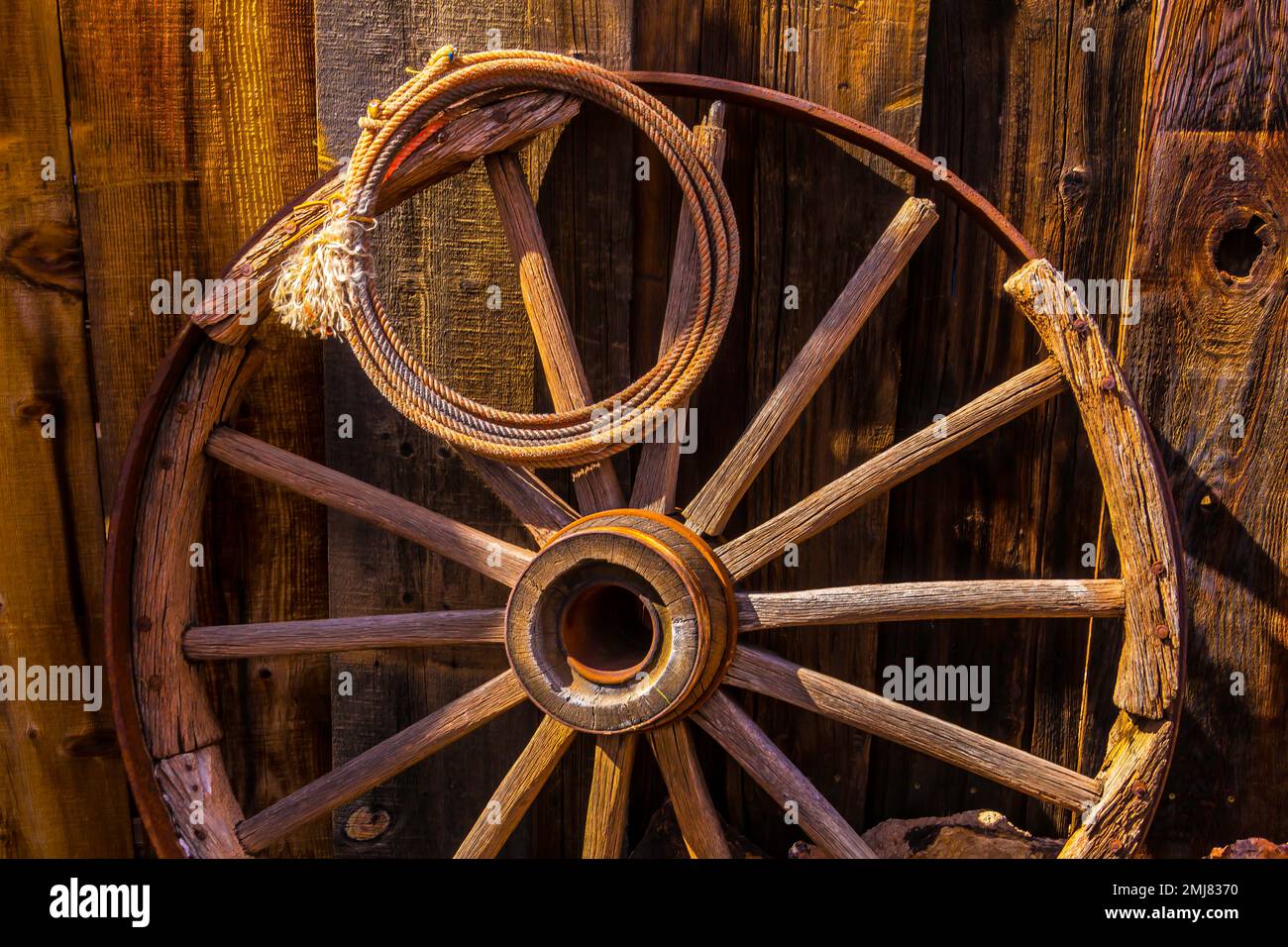 Western Rope And Wooden Wheel Stock Photo - Alamy