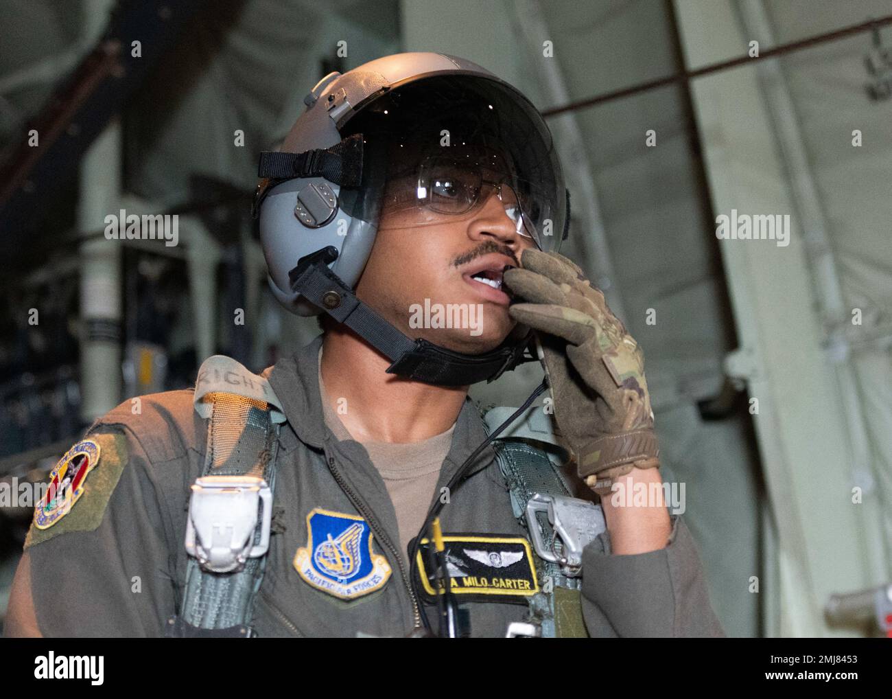 Senior Airman Milo Carter, 36th Airlift Squadron loadmaster, talks to ...
