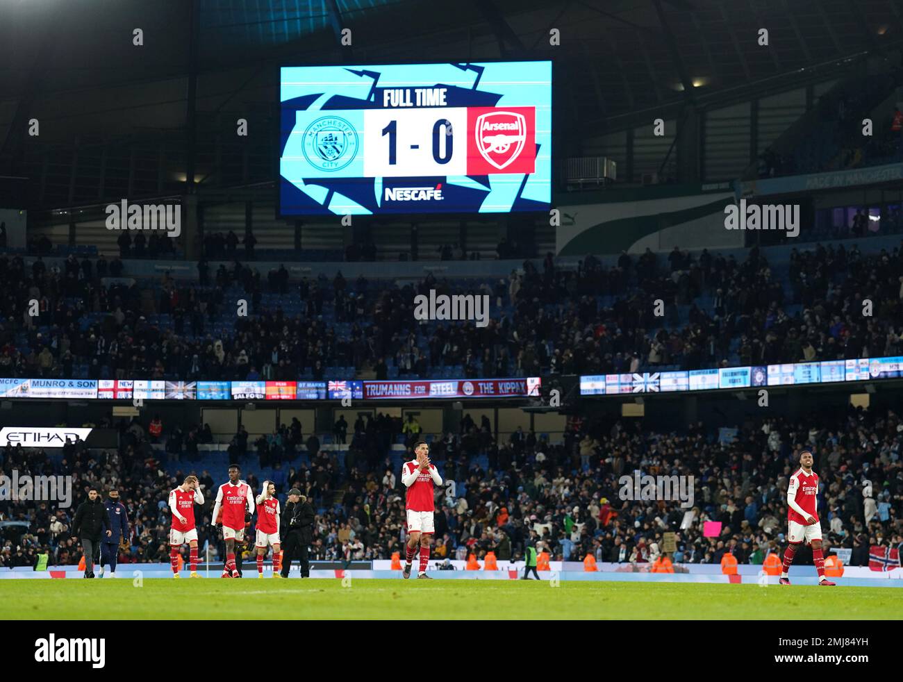 Arsenal players appear dejected as the scoreboard displays the final ...