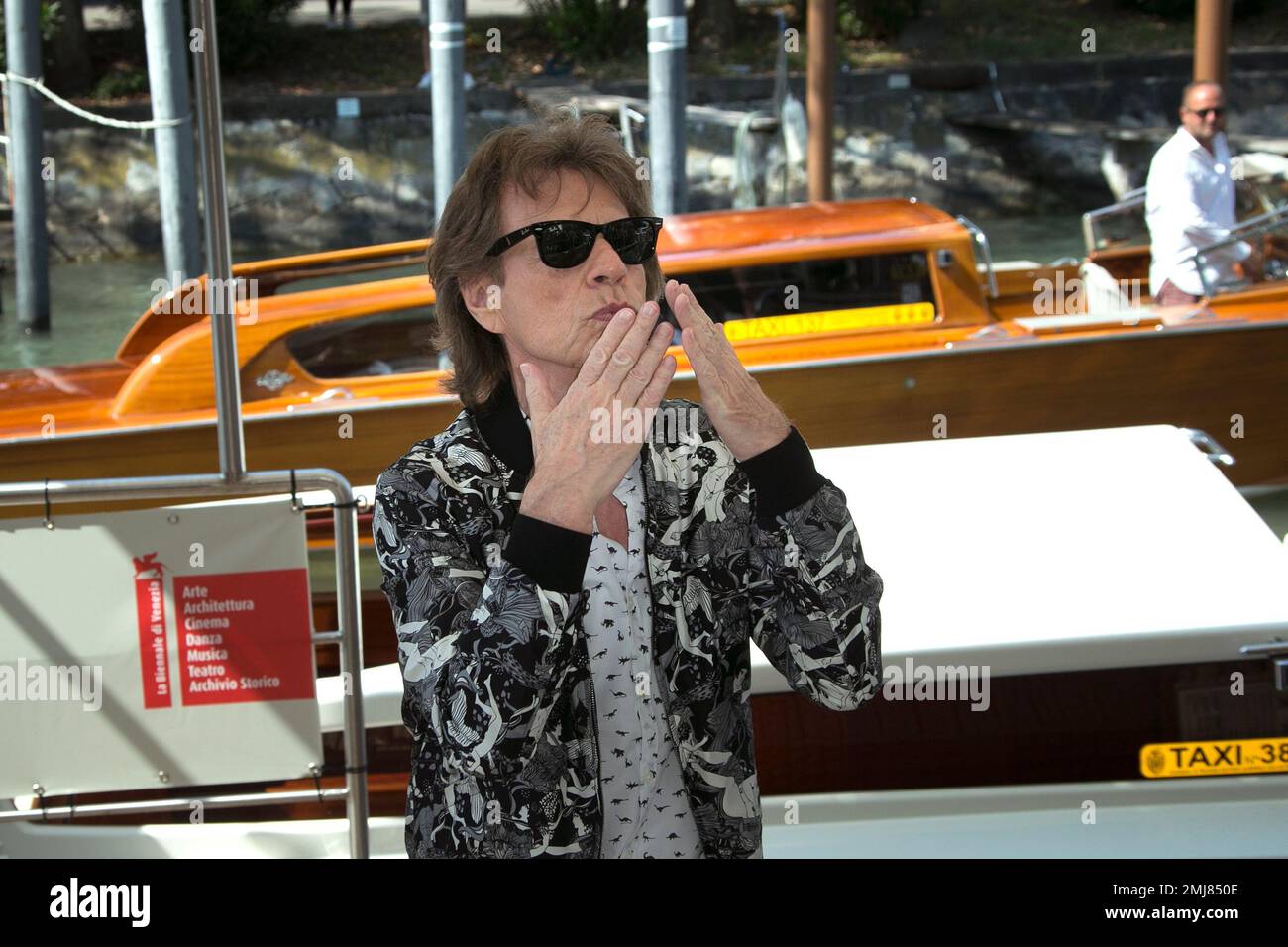 Actor Mick Jagger blows a kiss for fans upon arrival for the photo call ...