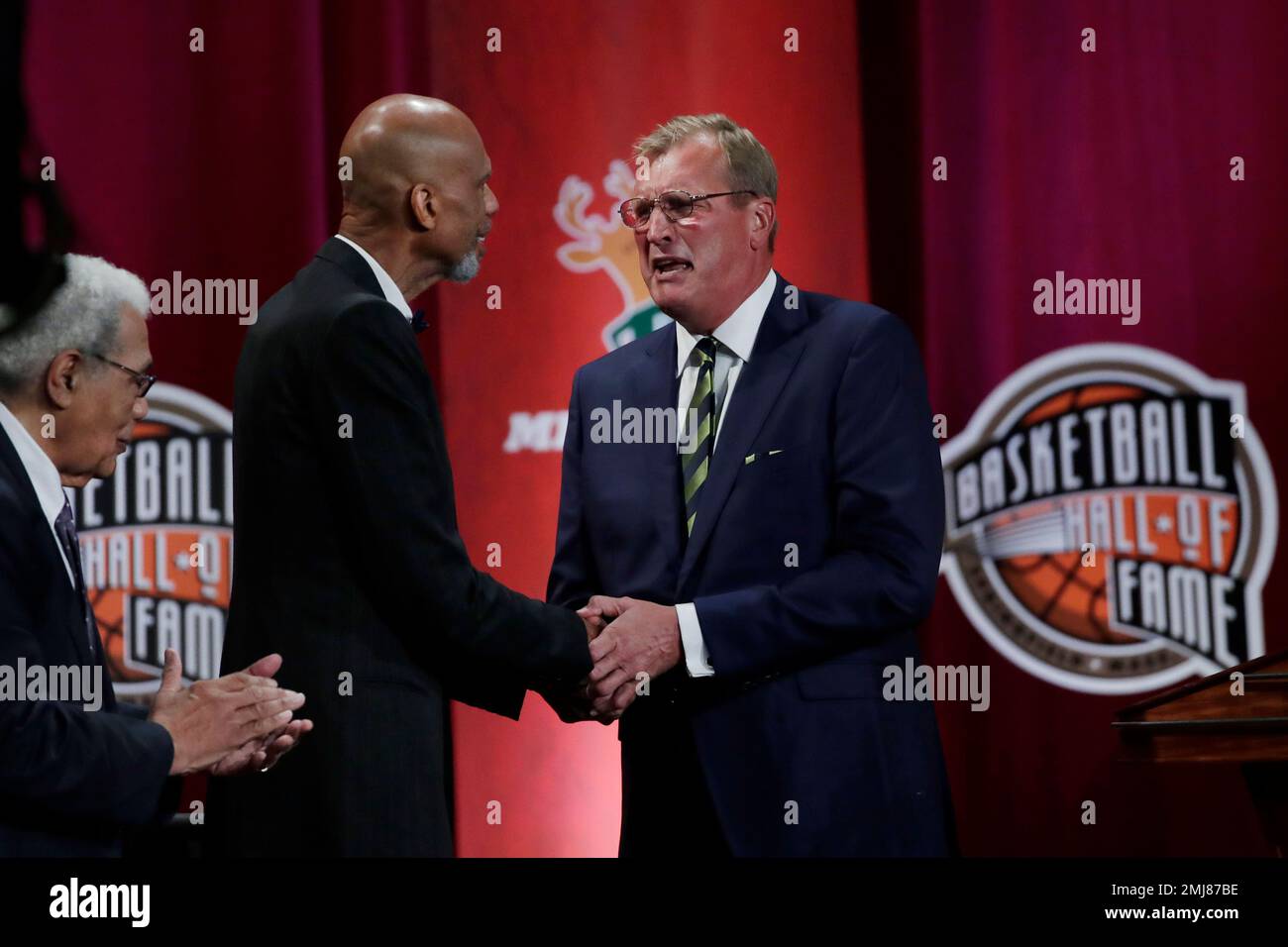 Inductee Jack Sikma, right, shakes hands with presenter Kareem Abdul ...