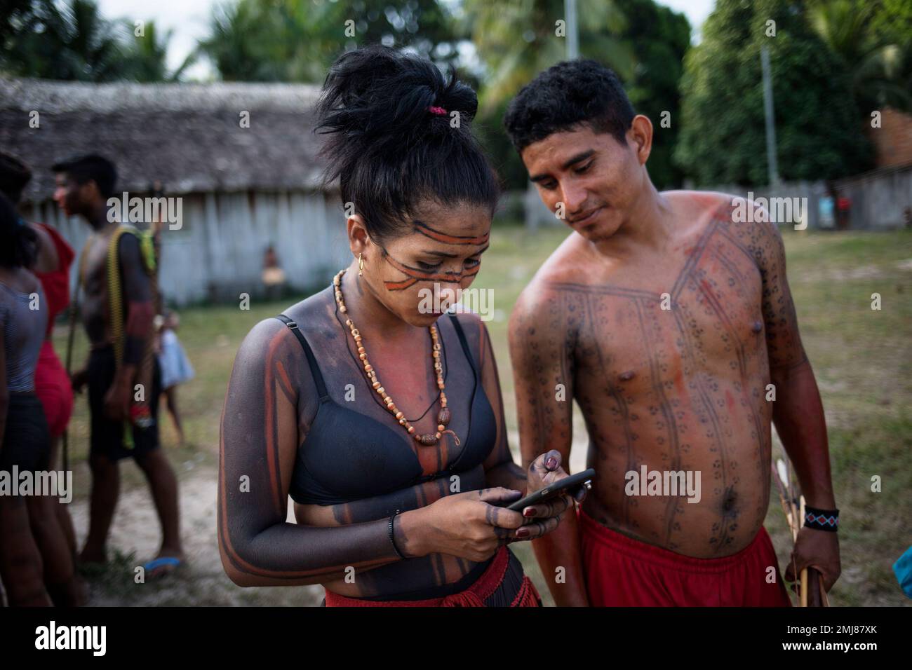 In this Sept. 3, 2019 photo, a woman checks her cell phone during a ...