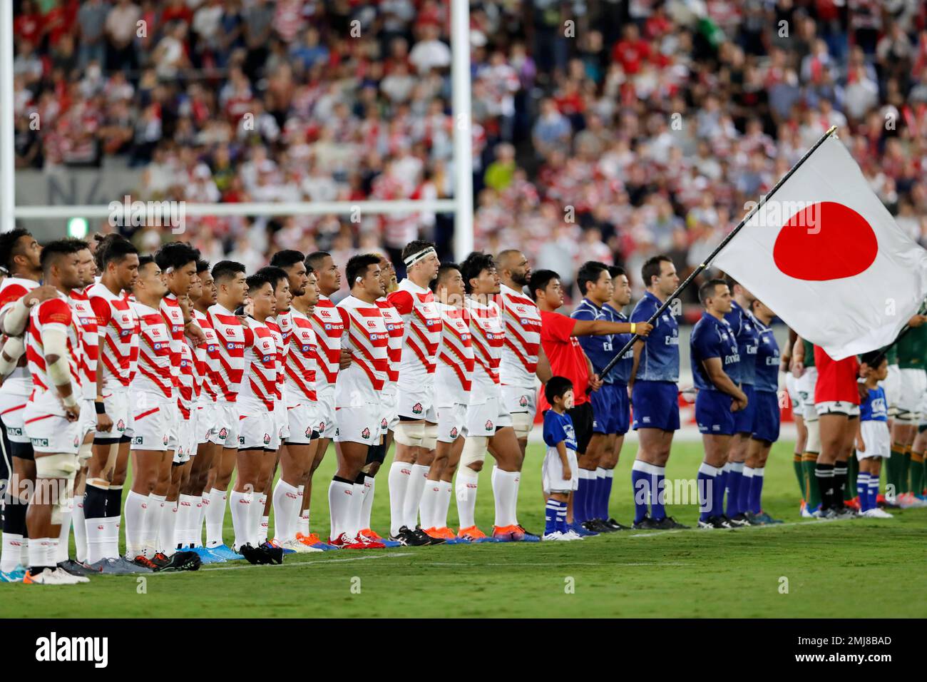 Players for the team Japan line up on the field during the national ...