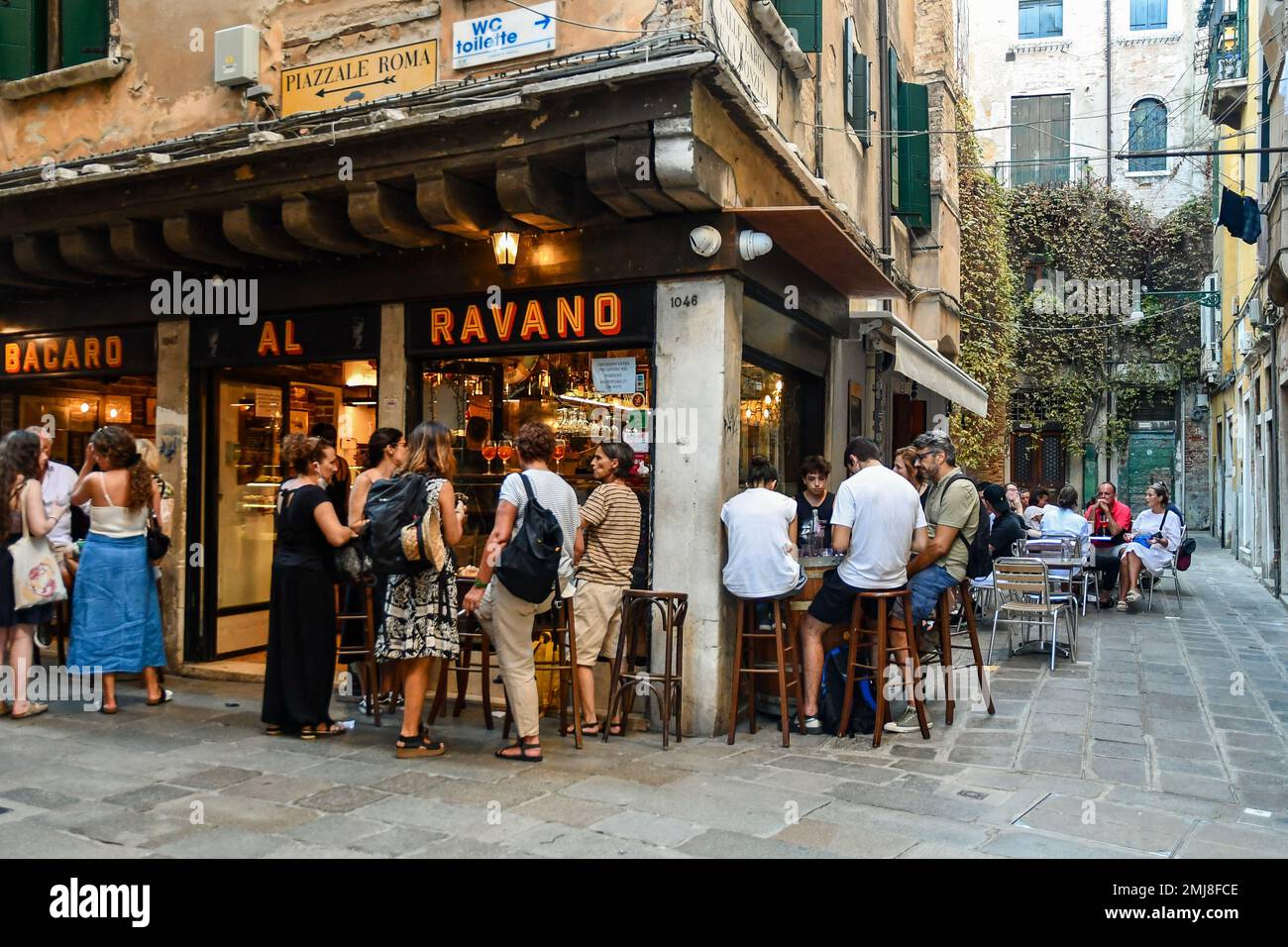 People taking aperitif in a typical Venetian bacaro (wine bar) in the ...