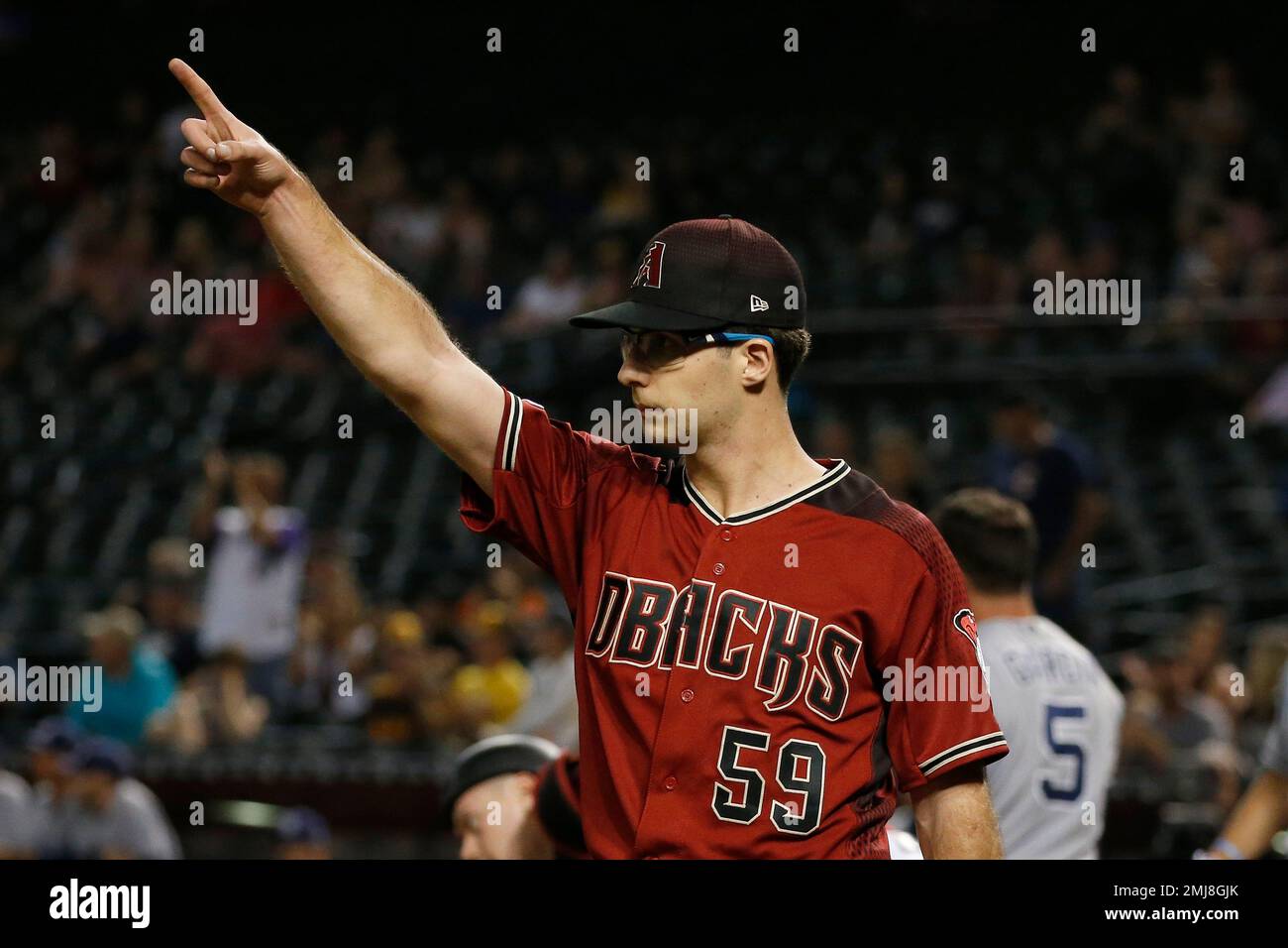 Arizona Diamondbacks starting pitcher Zac Gallen points to a teammate ...