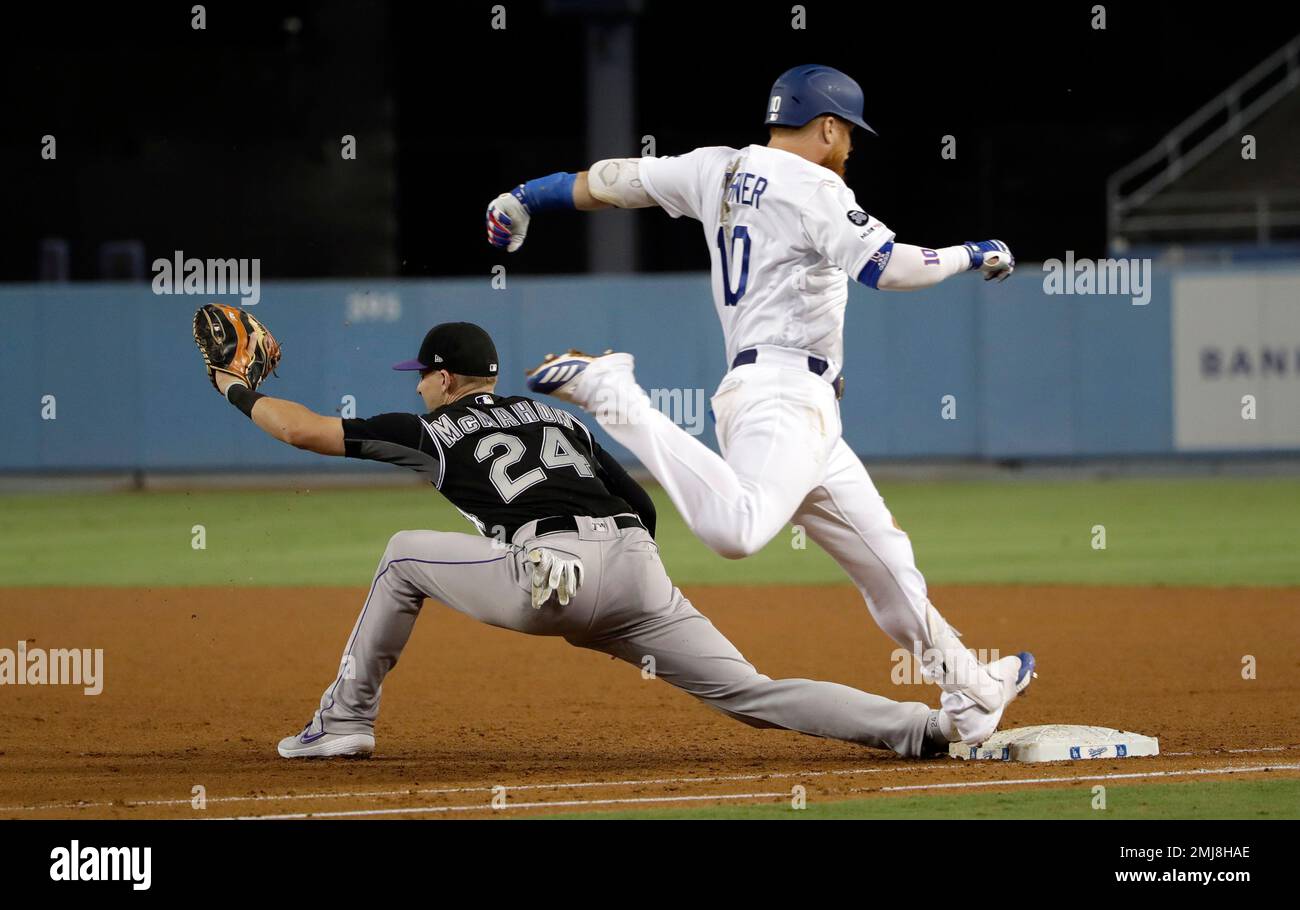 Los Angeles Dodgers' Justin Turner, right, is safe at first base on a ...