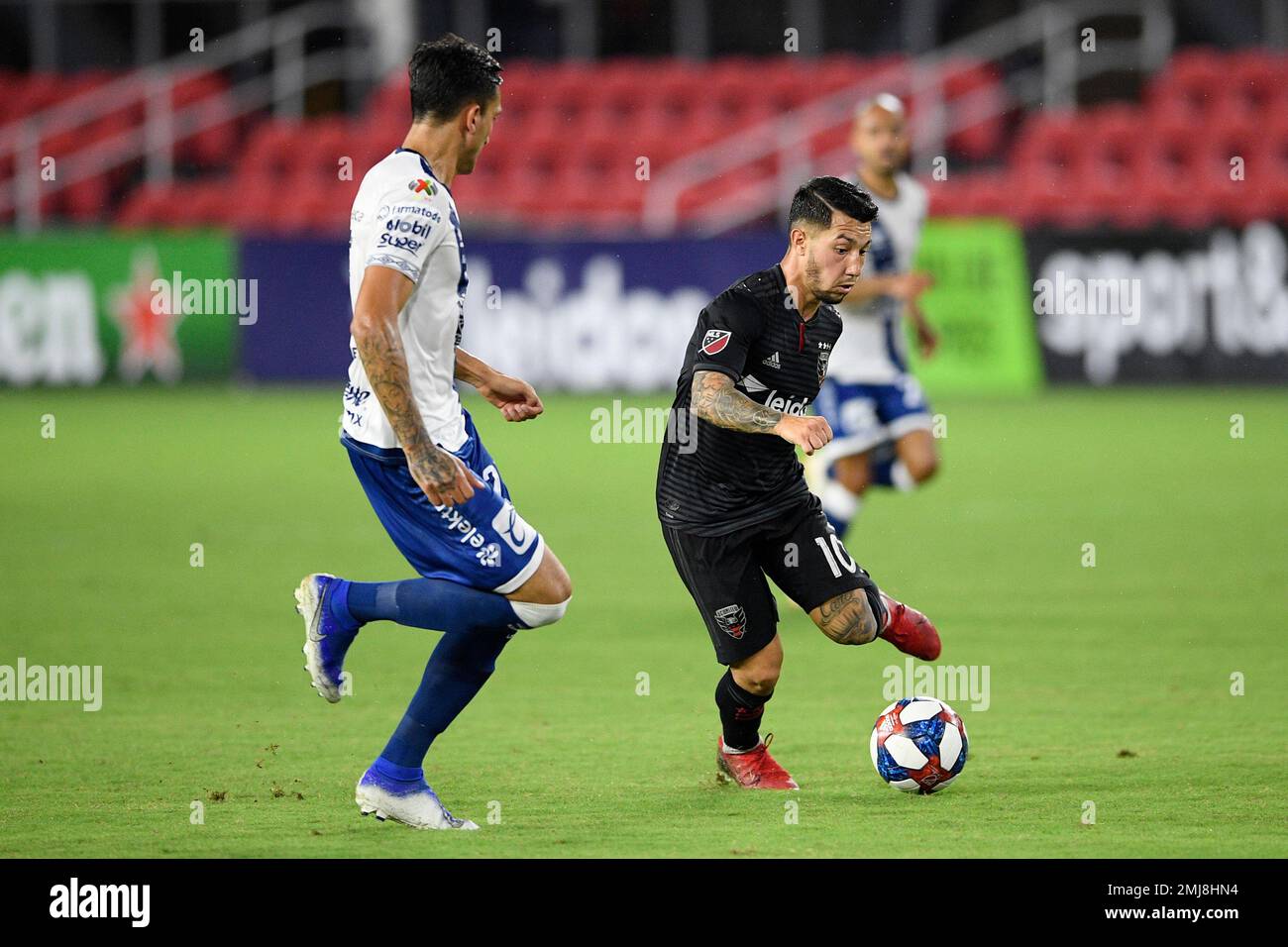 D.C. United midfielder Luciano Acosta (10) moves the ball next to ...