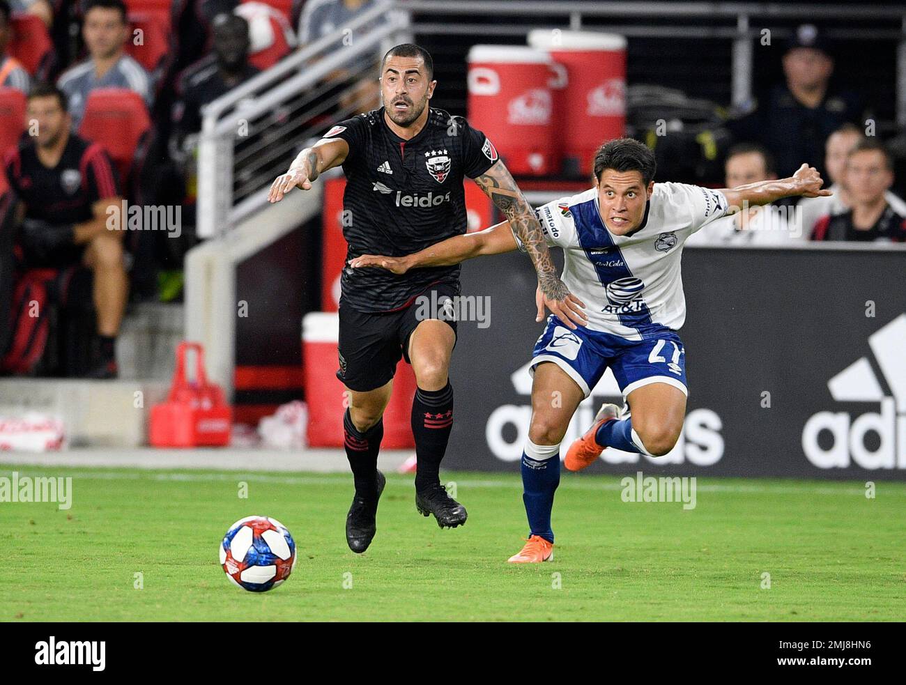 D.C. United defender Marquinhos Pedroso (6) and Puebla midfielder Alan ...