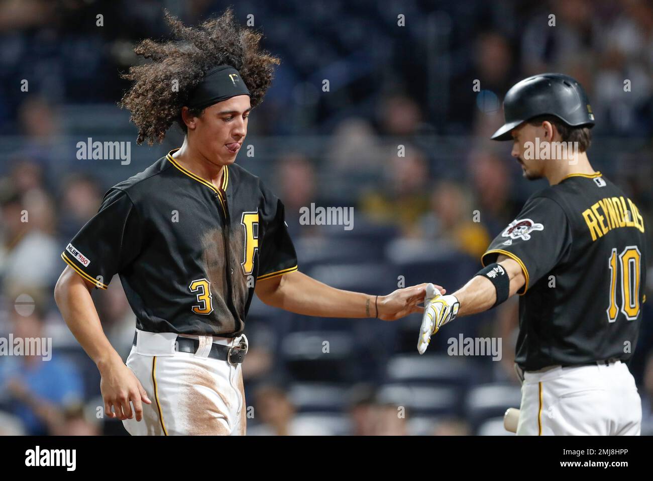 Pittsburgh Pirates' Cole Tucker is greeted by Adam Frazier after ...