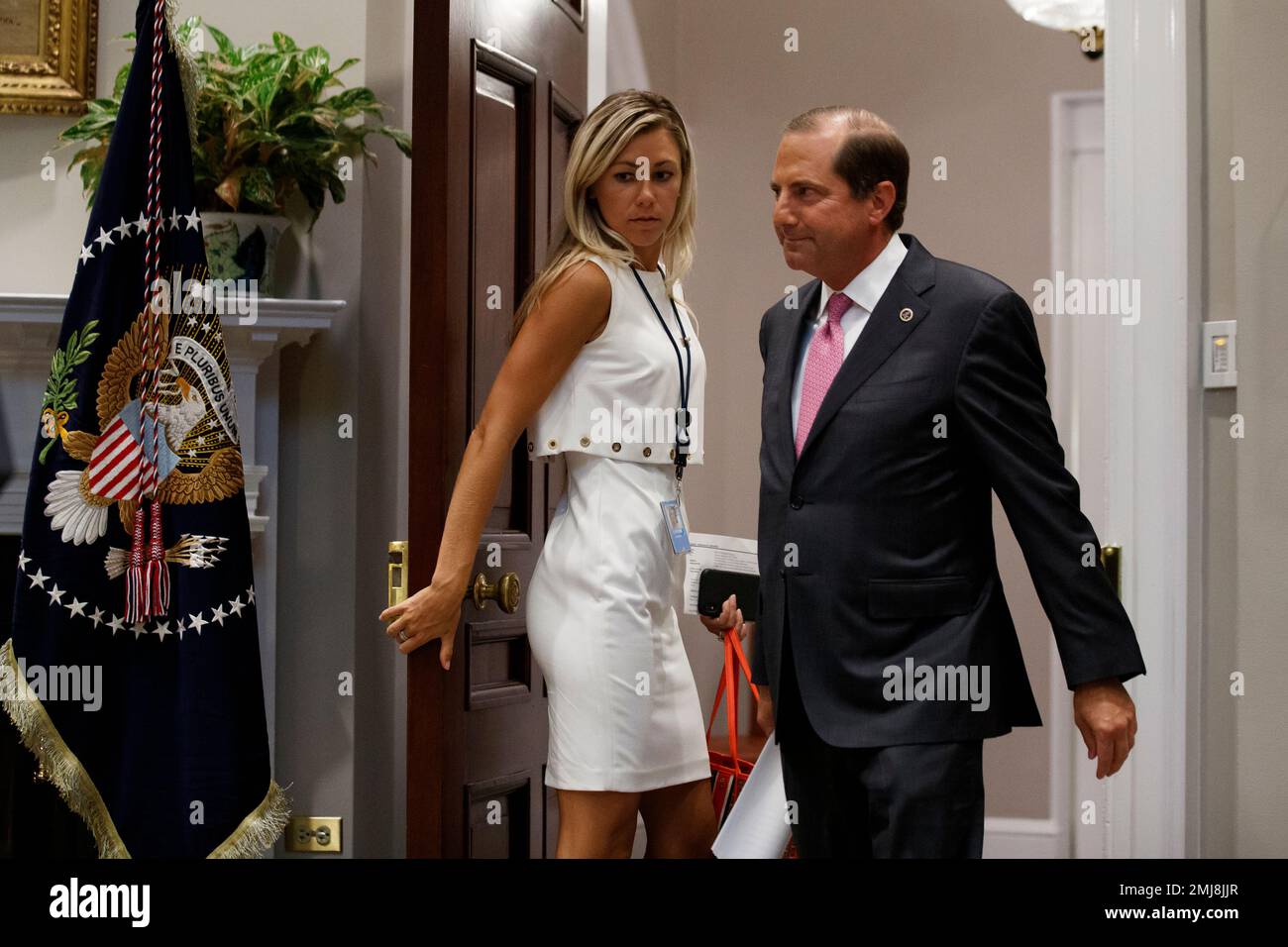 Special Assistant Catharine Cypher, left, holds the door for Health and ...