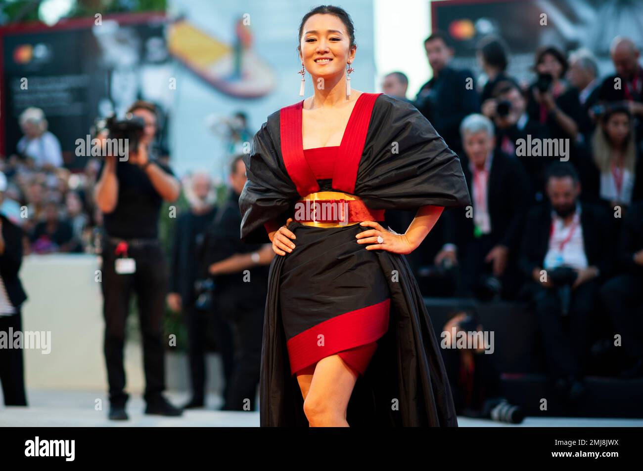 Gong Li poses for photographers upon arrival at the premiere of the ...
