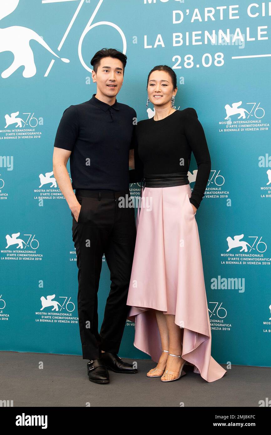 Actors Mark Chao, left, and Gong Li poses for photographers at the ...