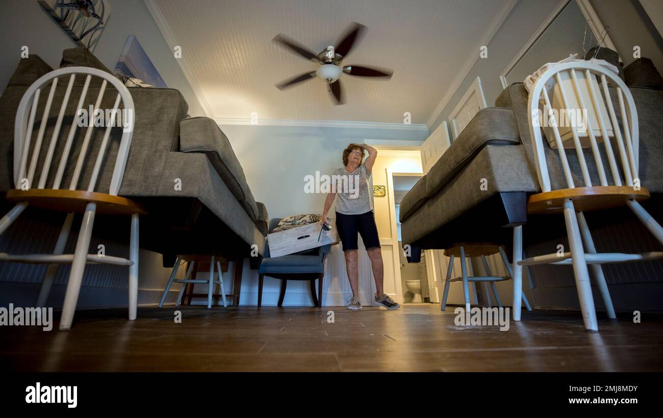 Debbie Pagan checks her raised up furniture one last time before she ...