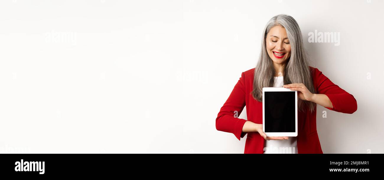 Business. Successful asian businesswoman in red blazer showing blank ...