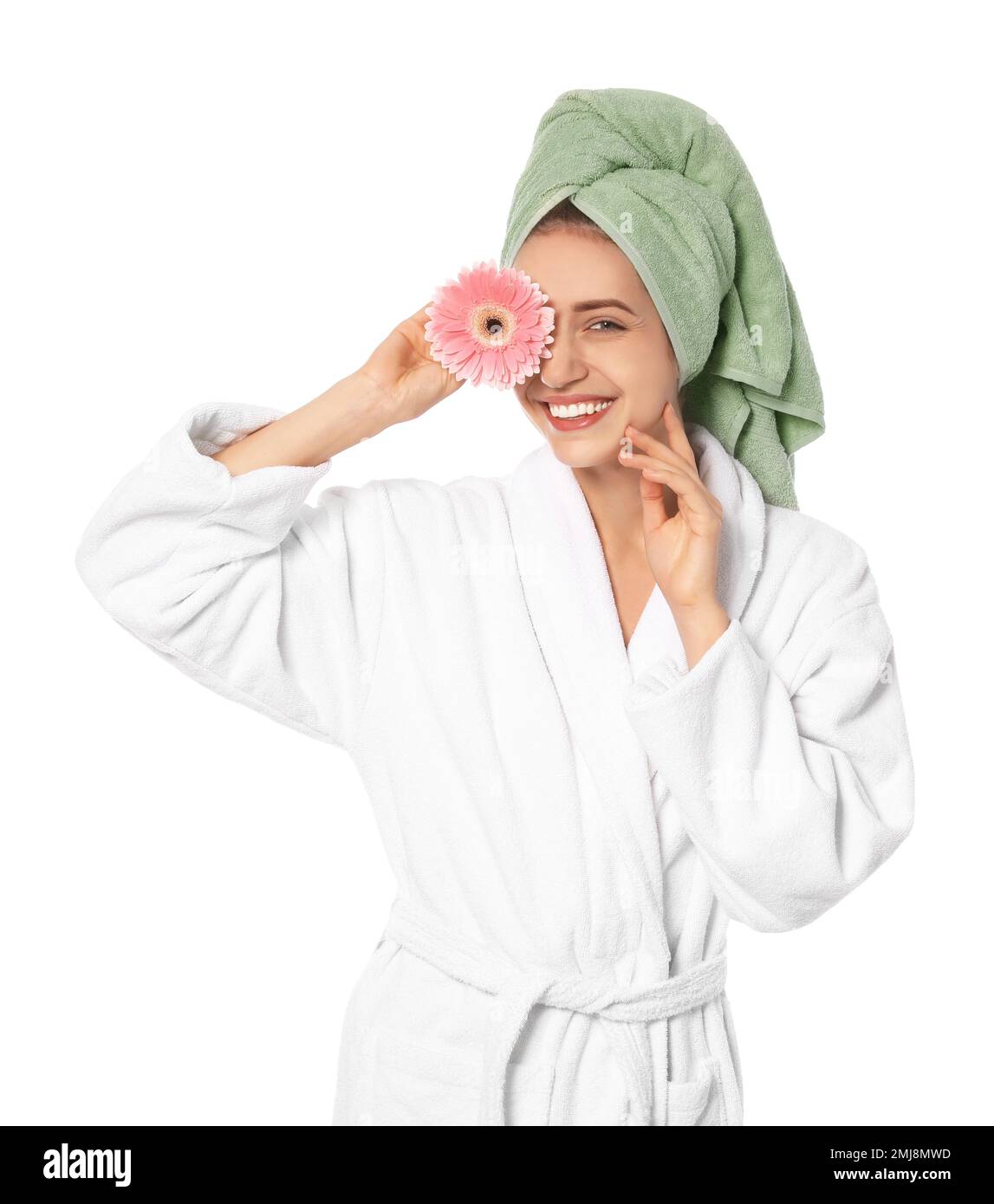 Beautiful young woman with flower wearing bathrobe on white background ...