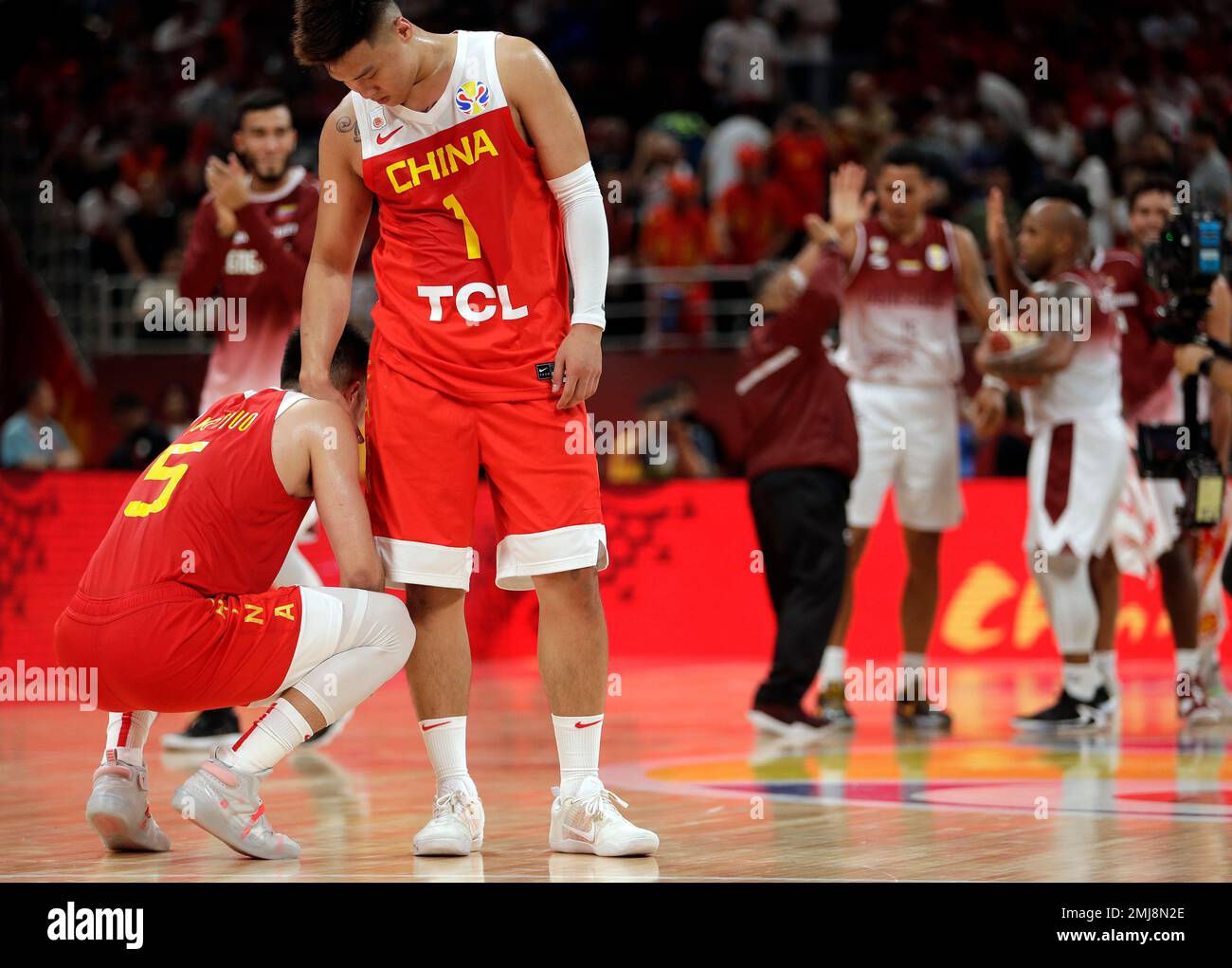 Zhao Rui, right, console teammate Fang Shuo of China after their loss ...