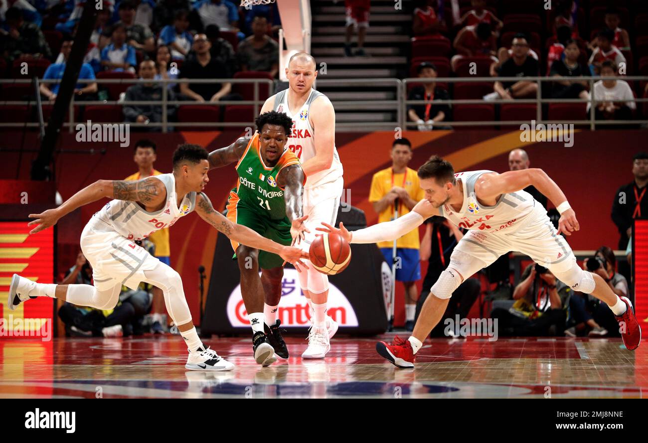A.J. Slaughter, left, and Mateusz Ponitka of Poland and Deon Thompson ...