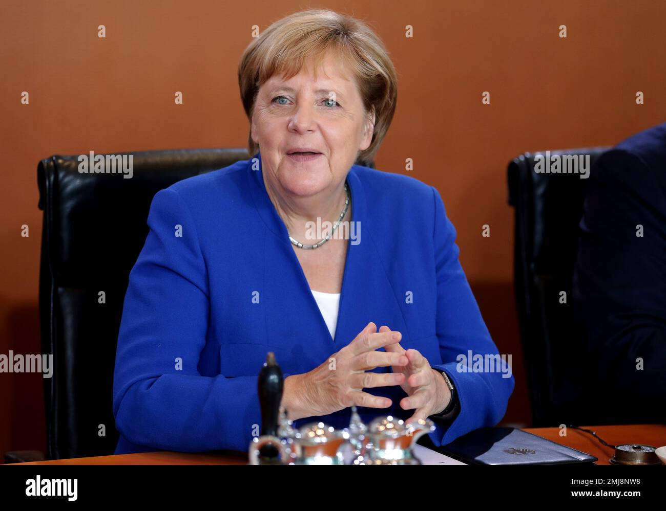 German Chancellor Angela Merkel smiles as she arrives for the weekly ...