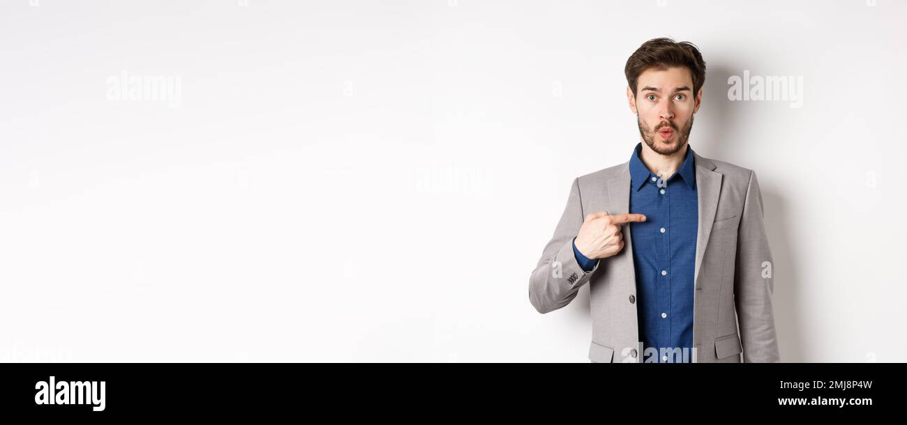 Who me. Surprised man in suit pointing at himself with disbelief ...
