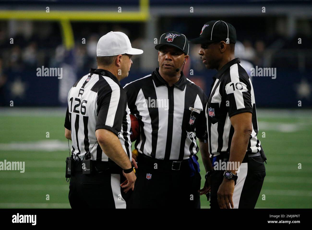 Referee Brad Rogers (125) talks with back judge Greg Steed, center, and ...