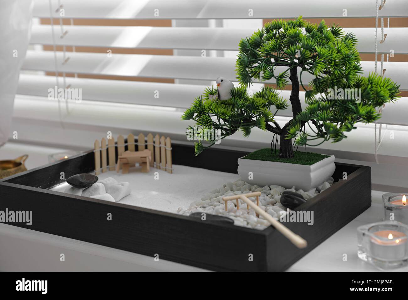 Beautiful miniature zen garden and candles on window sill Stock Photo ...