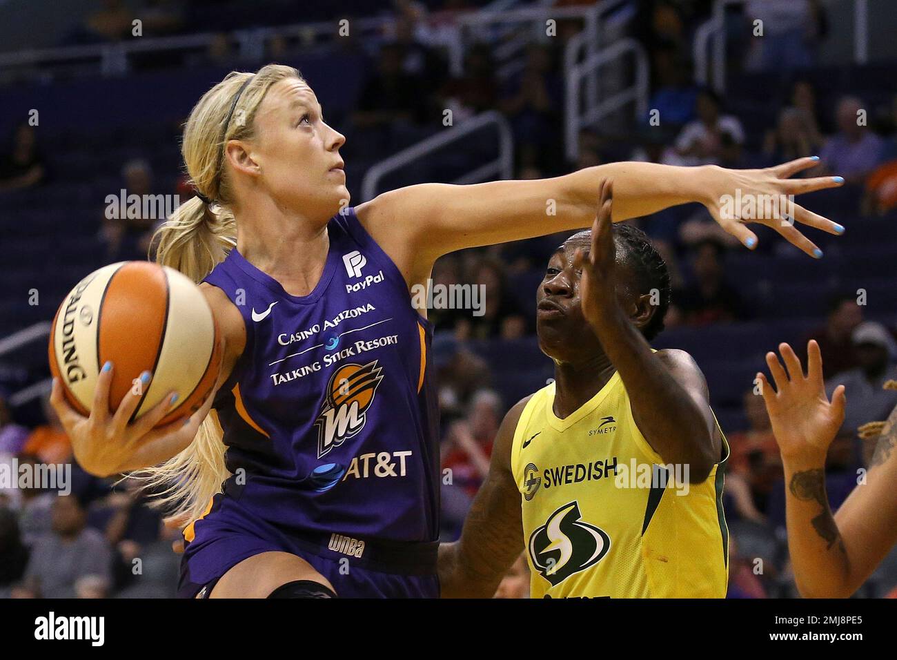 Phoenix Mercury guard Sophie Cunningham, left, drives past Seattle ...