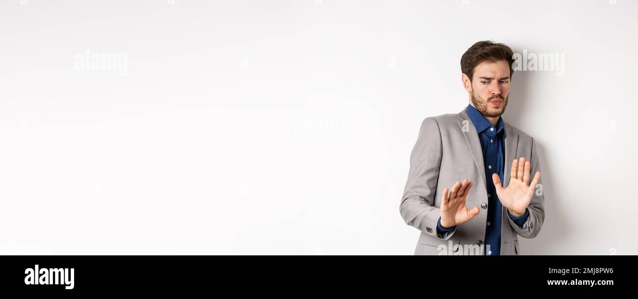 Stay away. Reluctant businessman step back with concerned disgusted ...