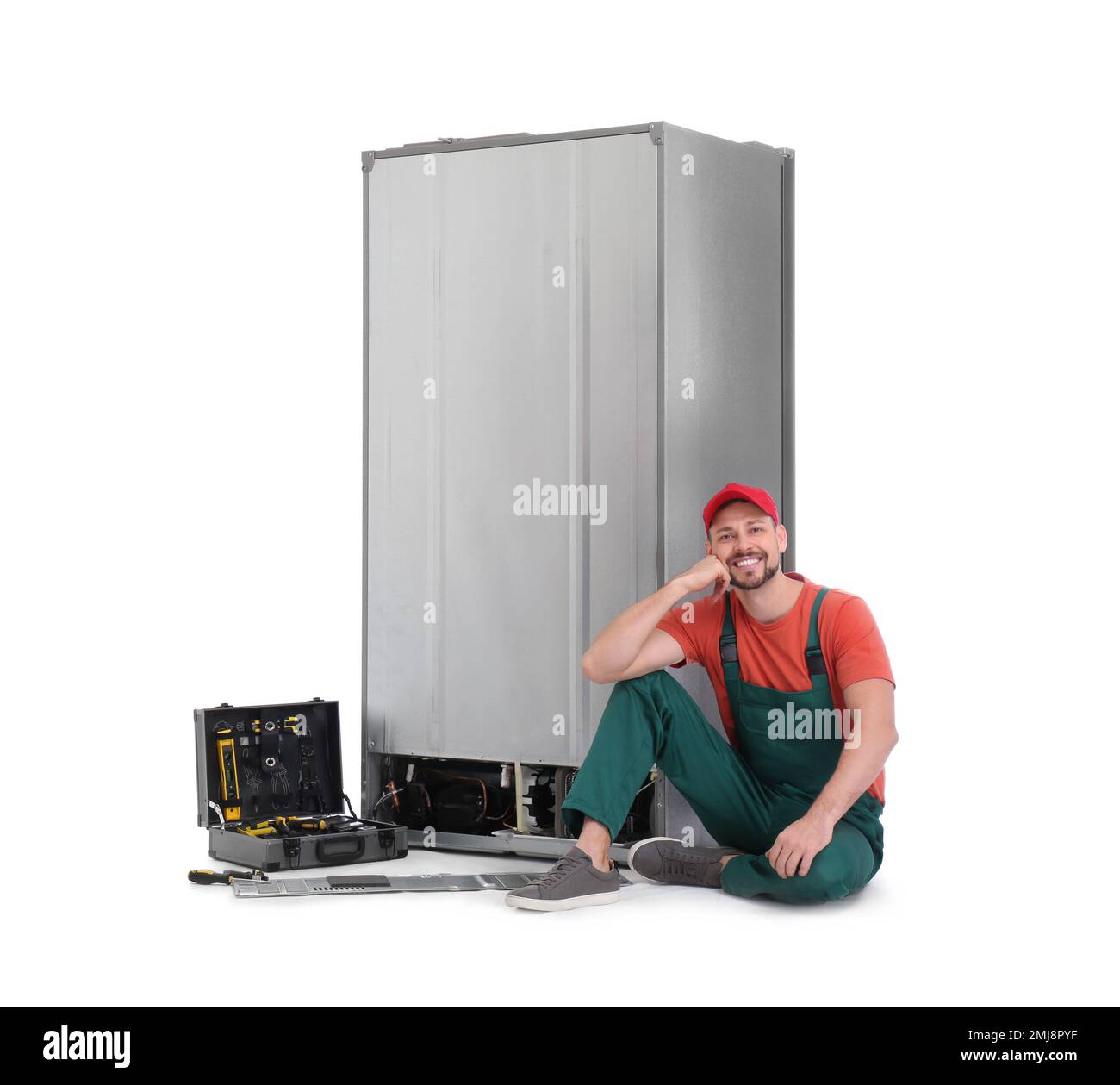 Male technician repairing refrigerator on white background Stock Photo ...
