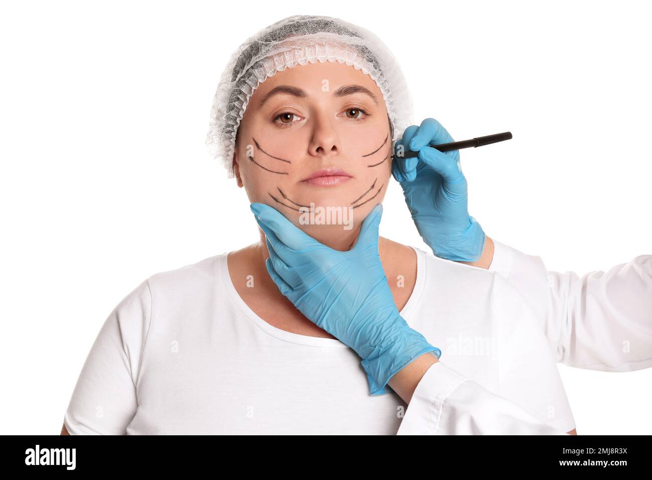 Doctor drawing marks on woman's face for cosmetic surgery operation ...