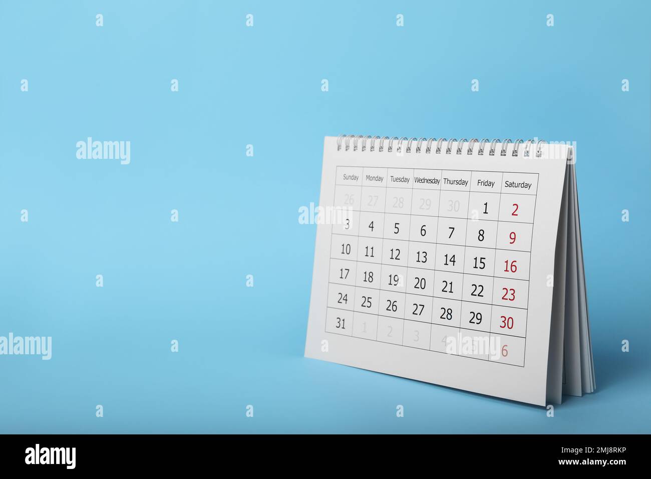 Paper calendar on light blue background, space for text. Planning ...