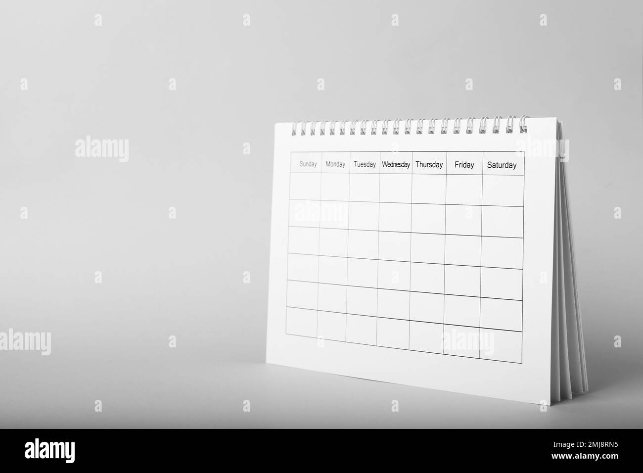 Blank paper calendar on grey background, space for text. Planning ...