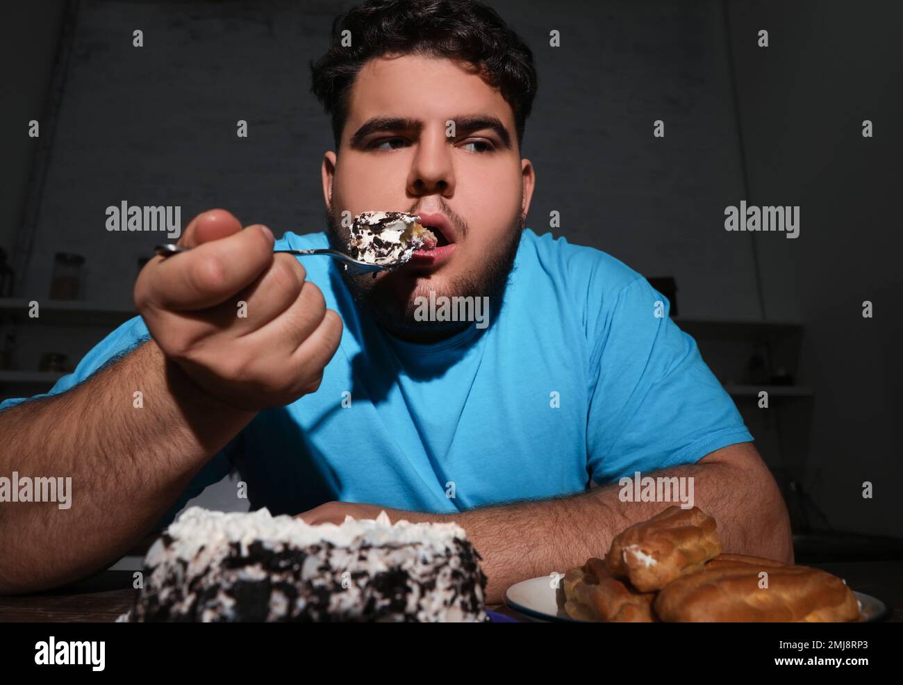 Obese man eating cake hi-res stock photography and images - Alamy