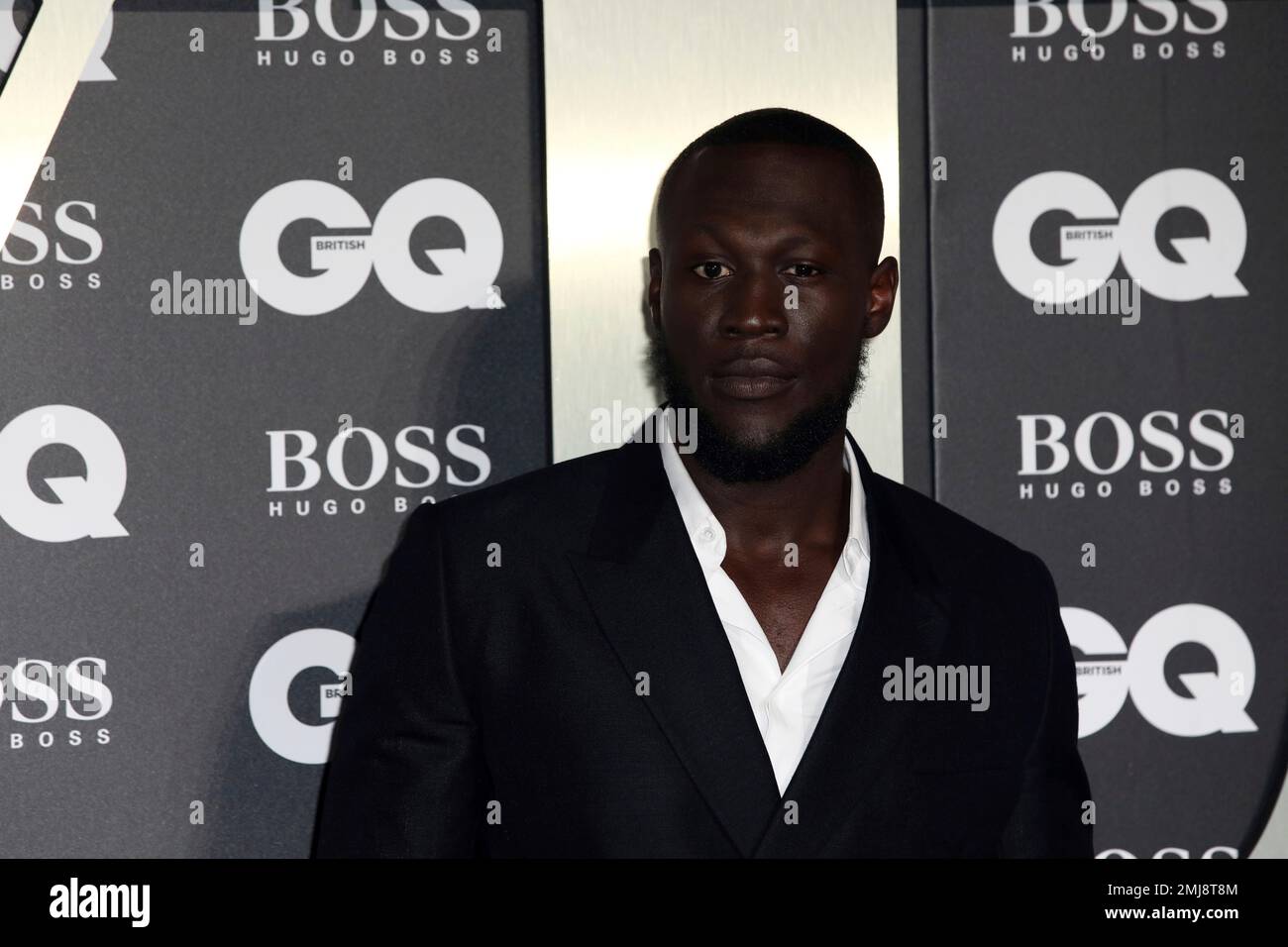 Musician Stormzy poses for photographers on arrival at the GQ Men of ...