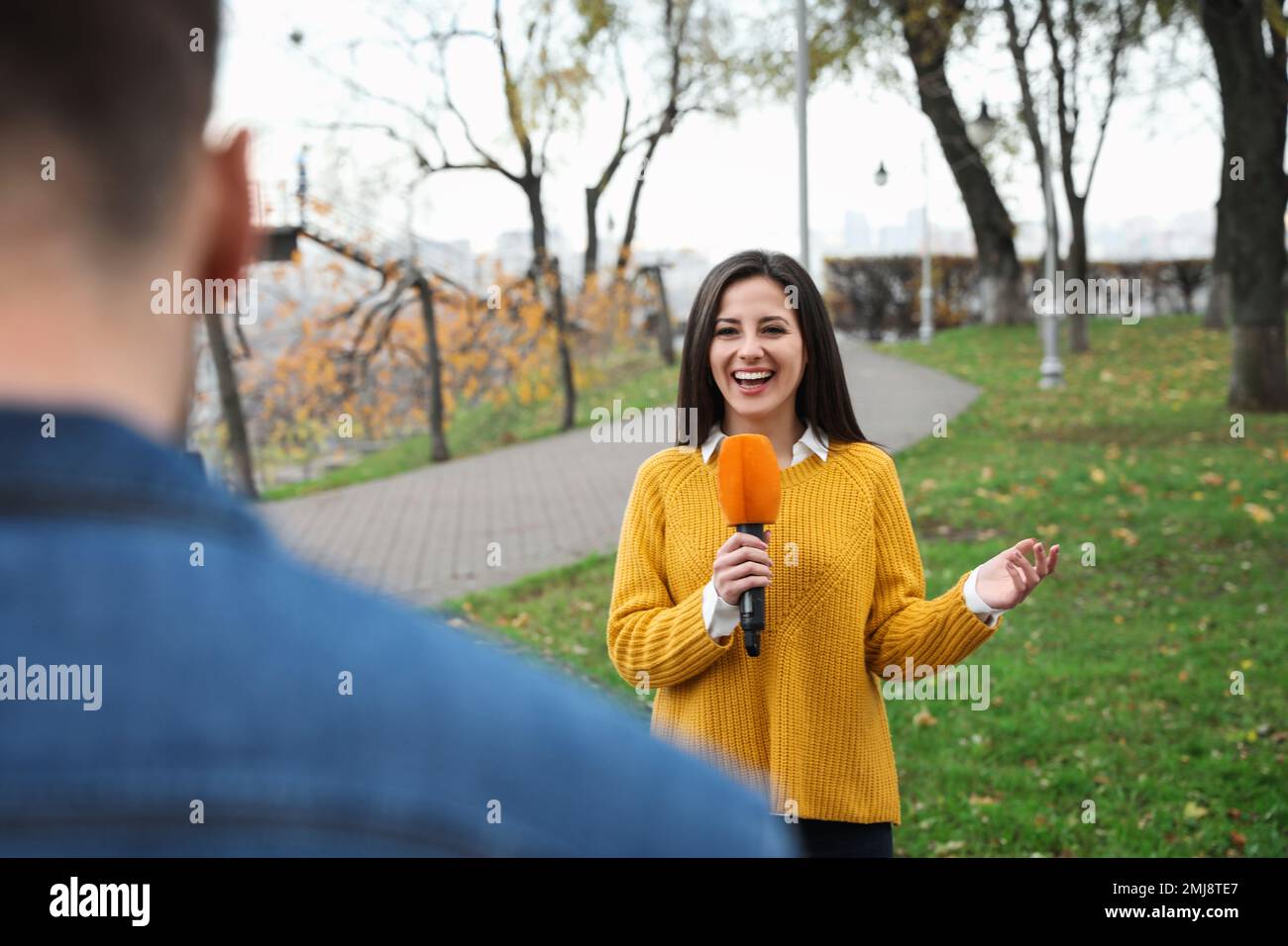 Young woman journalist reporting hi-res stock photography and images ...